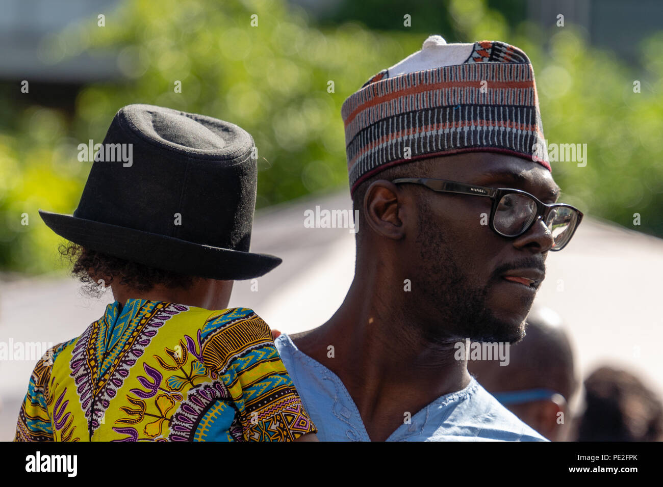 Father of African origin with son wearing fedora at Coleur Cafe 208 in ...