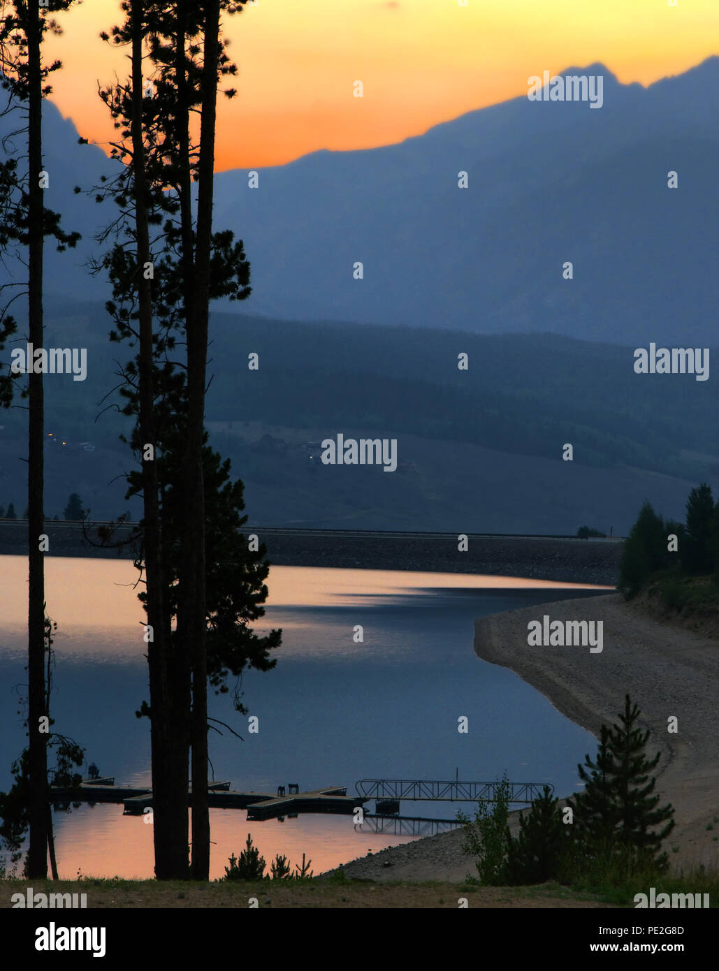 The mountains and sunset reflect on the waters of Lake Dillon in the ...