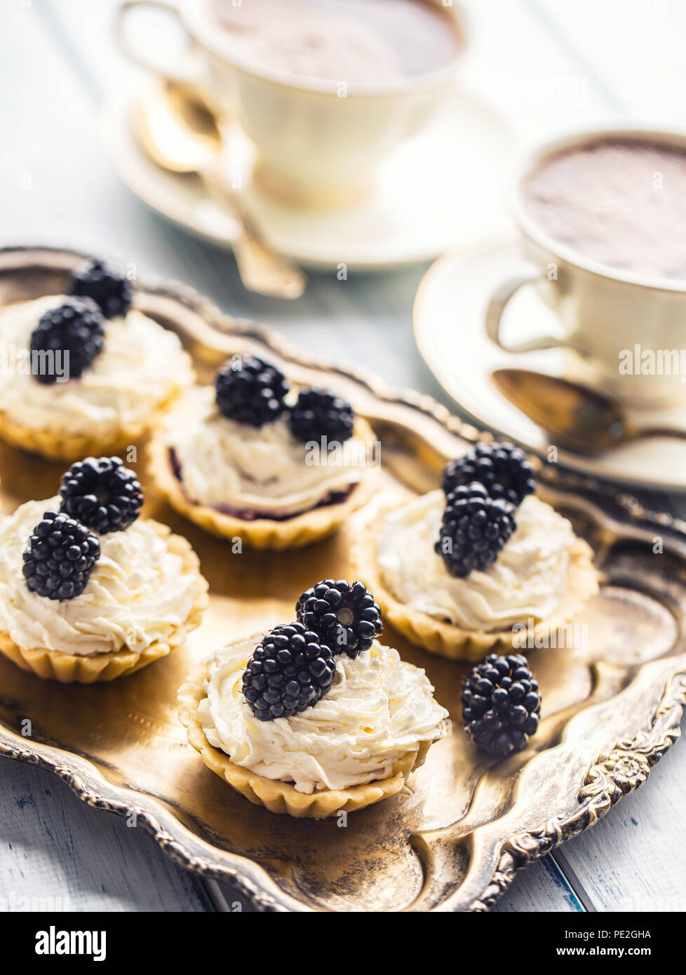 Mini tartlets with blackberries whipped cream and coffee Stock Photo ...