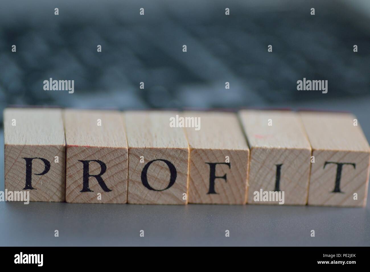 Illustration Financial terms written on wooden blocks with blurred note ...