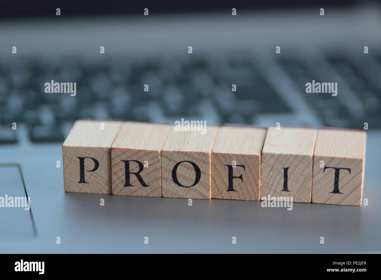 Illustration Financial terms written on wooden blocks with blurred note ...