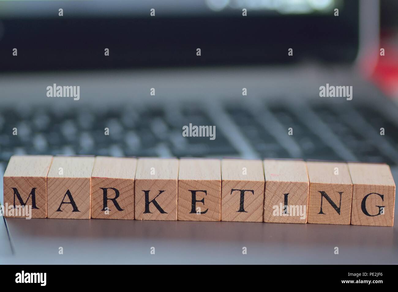 Illustration Financial terms written on wooden blocks with blurred note ...