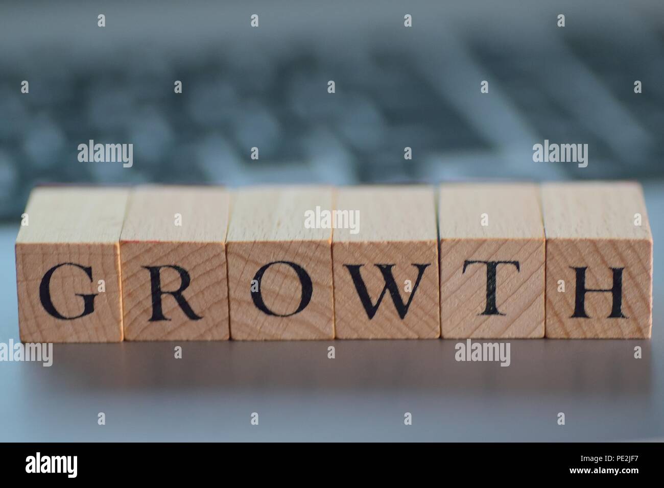 Illustration Financial terms written on wooden blocks with blurred note ...