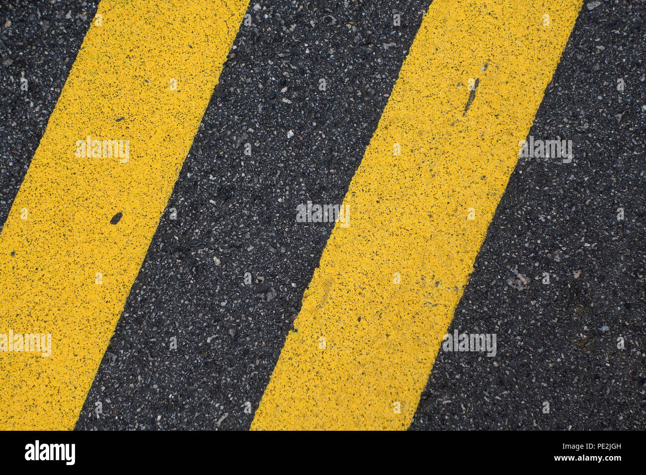 Black Road Pavement with Yellow Double Line Stock Photo - Alamy