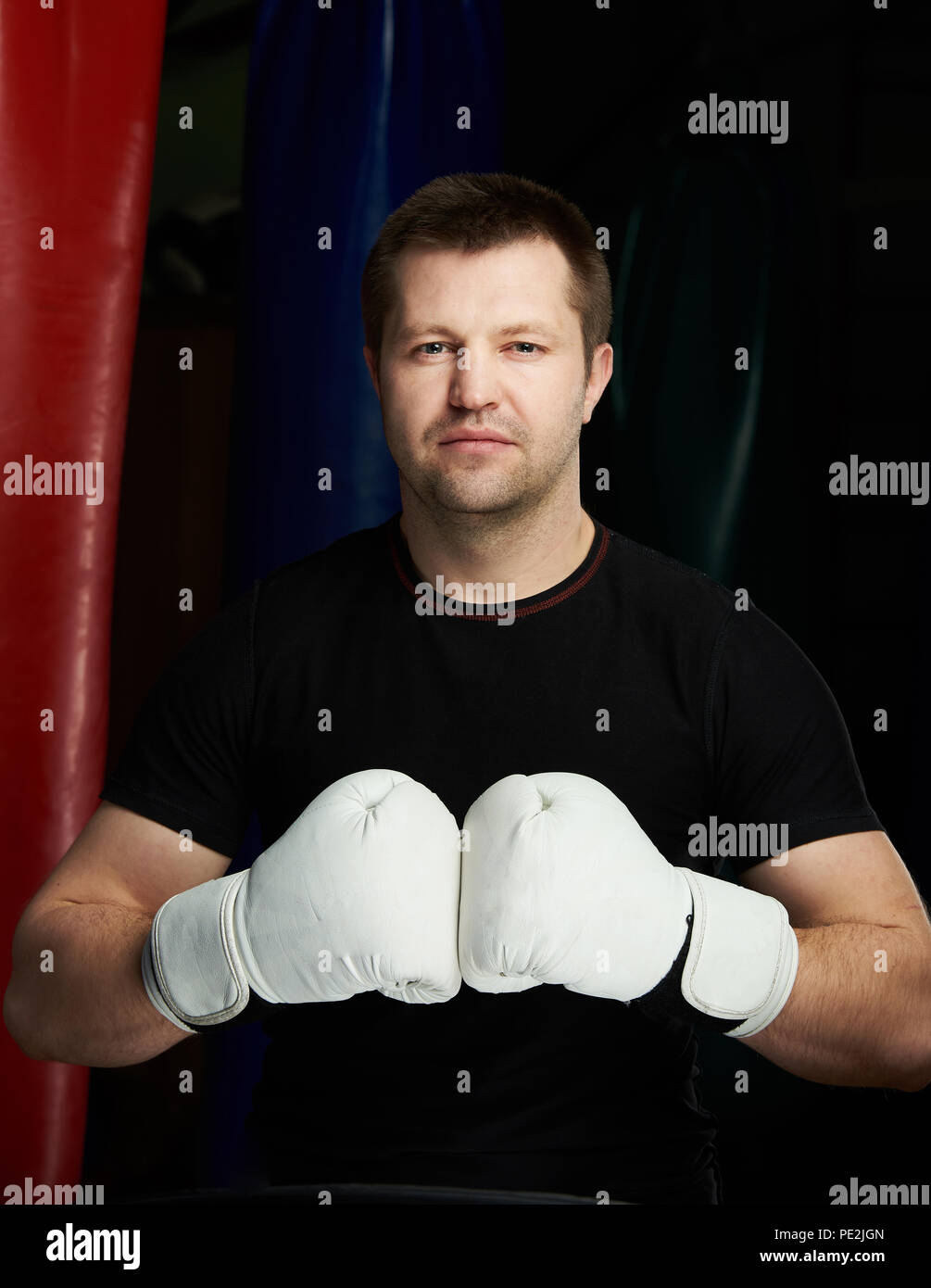 Caucasian boxing man portrait standing with gloves join together Stock ...