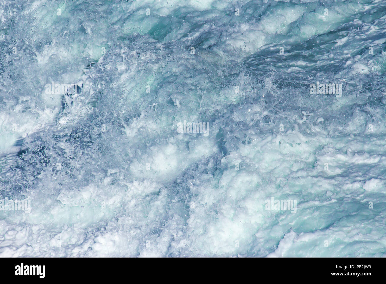 Aquatic background of sea surf waves close up with clear water and ...