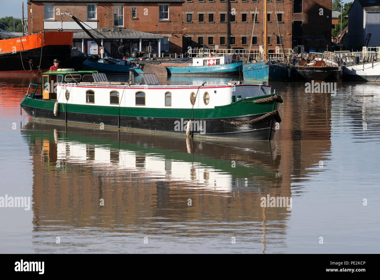 A narrow-beam Dutch barge style canal boat manoeuvring in the main ...