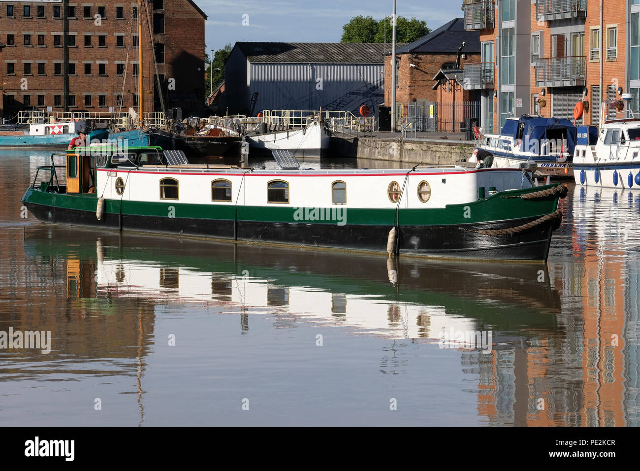 A narrow-beam Dutch barge style canal boat manoeuvring in the main ...