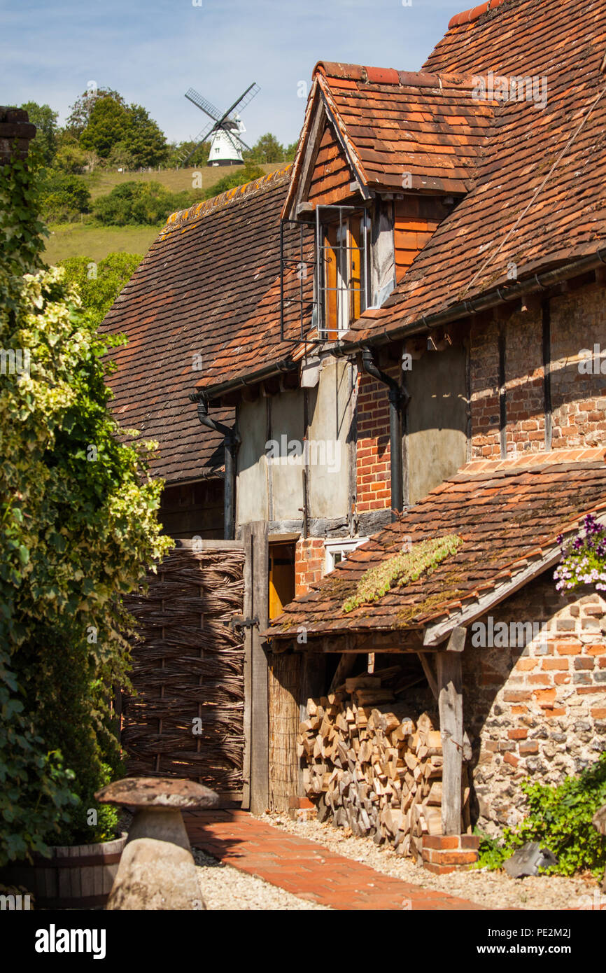 English country cottage with log store in the village of Turville ...