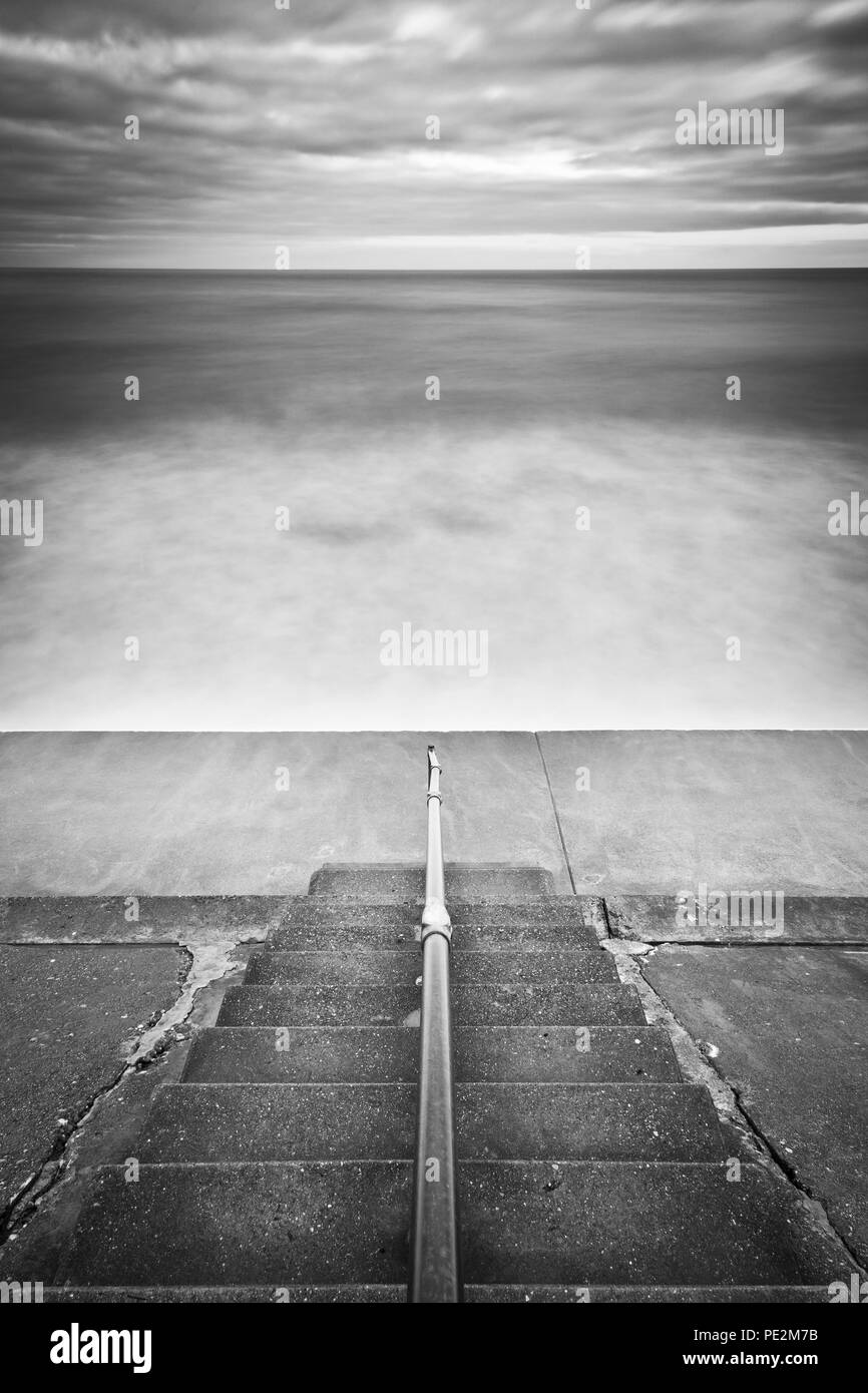 Concrete steps leading down to the sea on a stormy day Stock Photo - Alamy