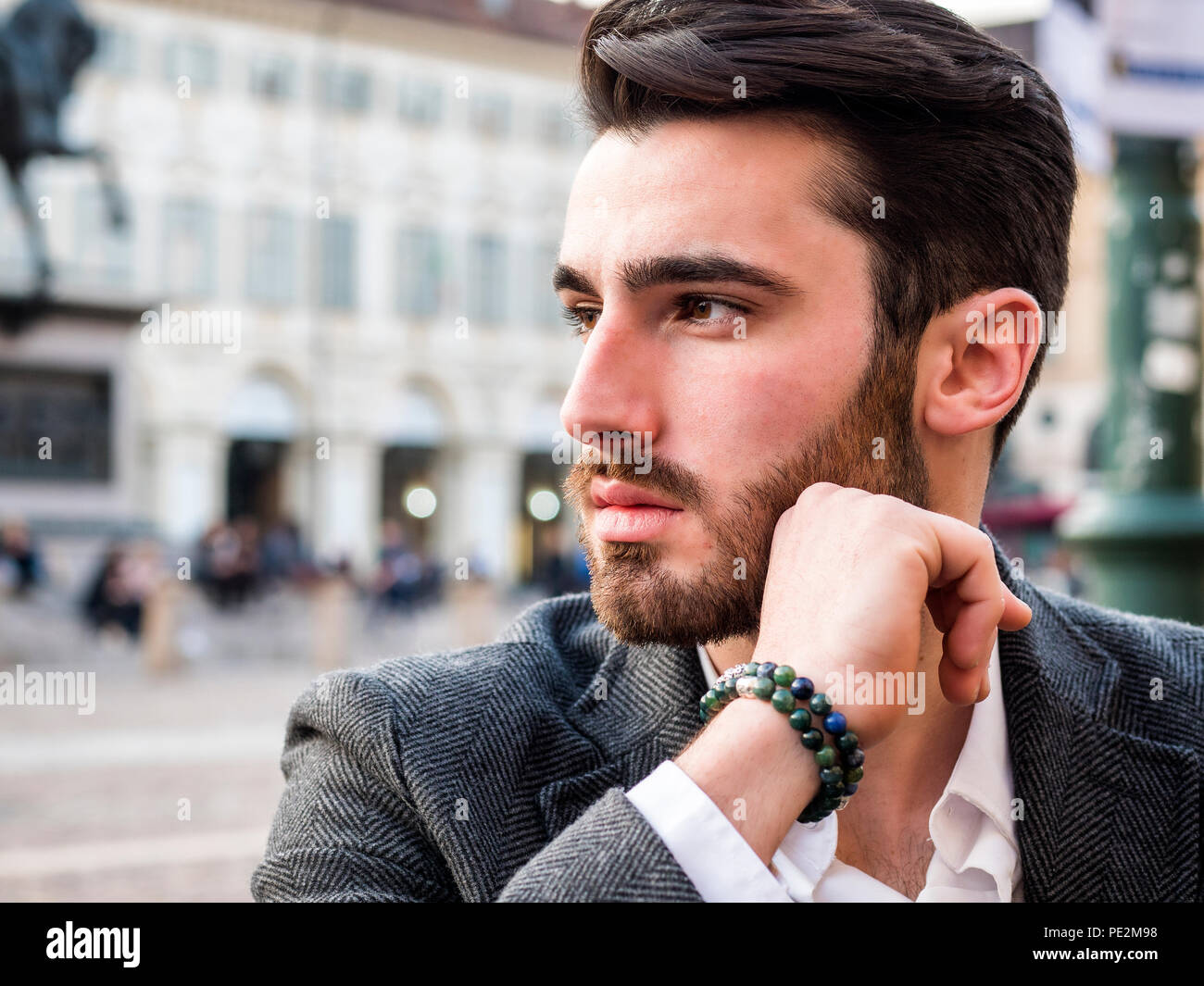 Serious man standing outside in elegant city center Stock Photo - Alamy