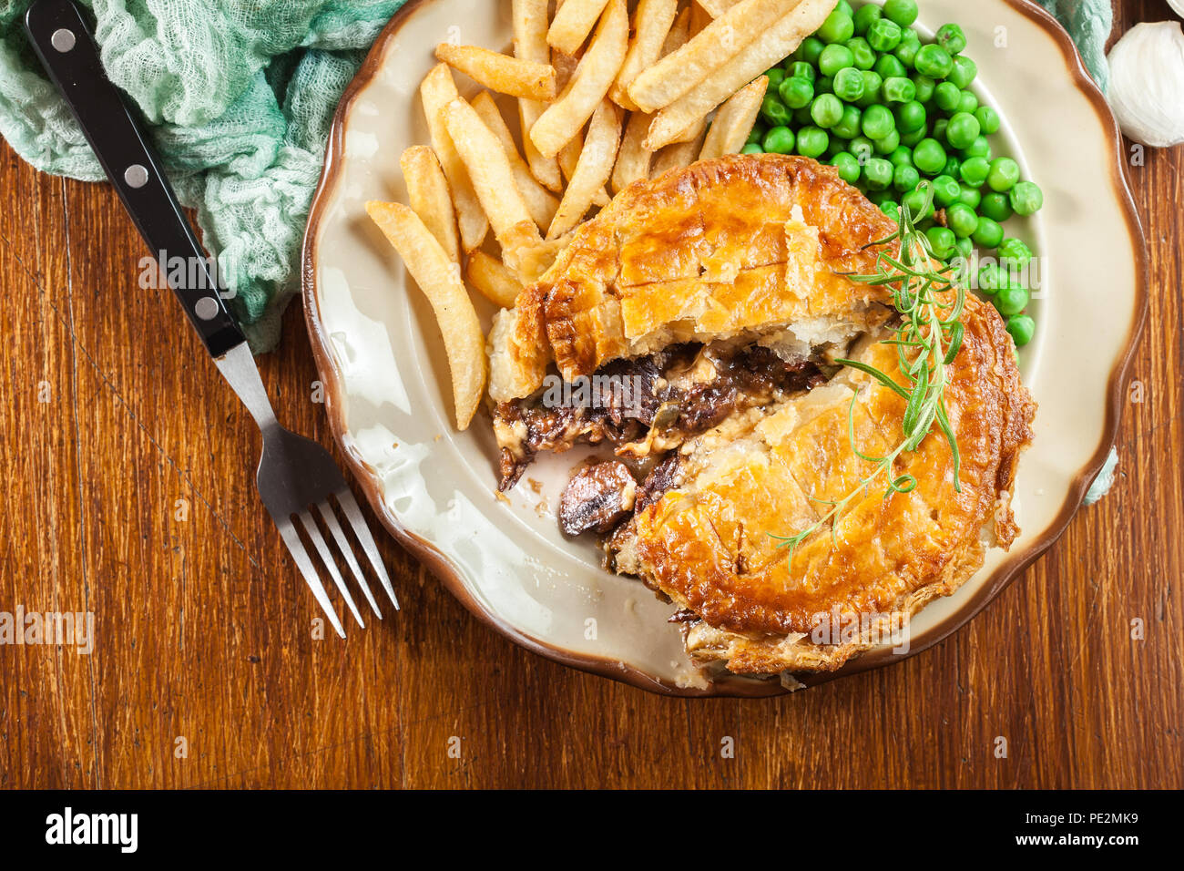 Homemade beef stew pie with french fries. Meat in puff pastry. Top view ...