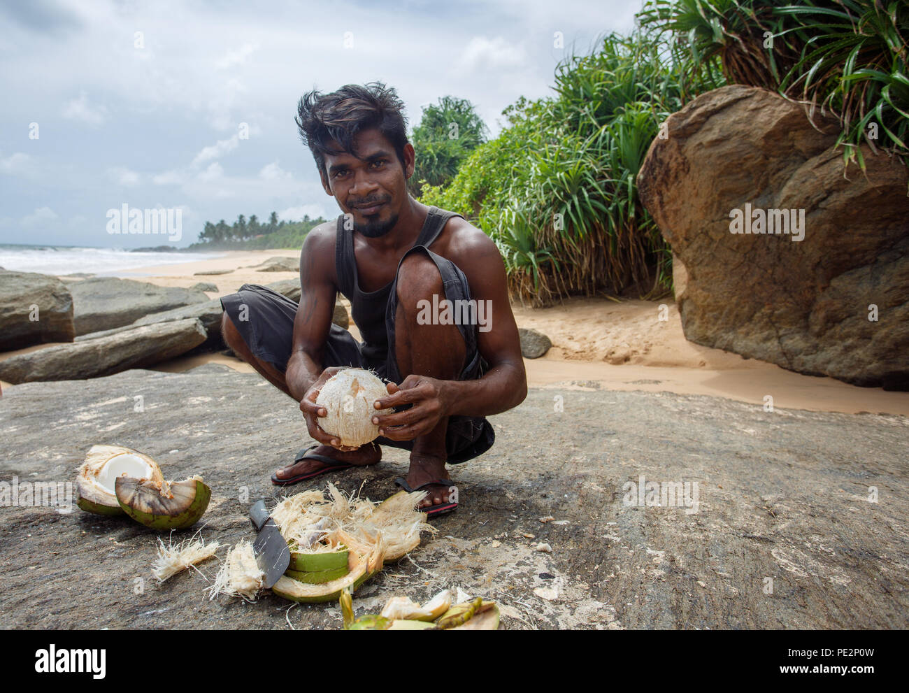Men posing with a coconut Stock Photo - Alamy