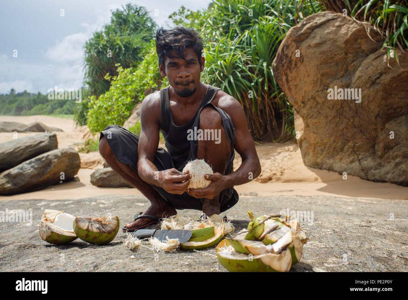 Men posing with a coconut Stock Photo - Alamy