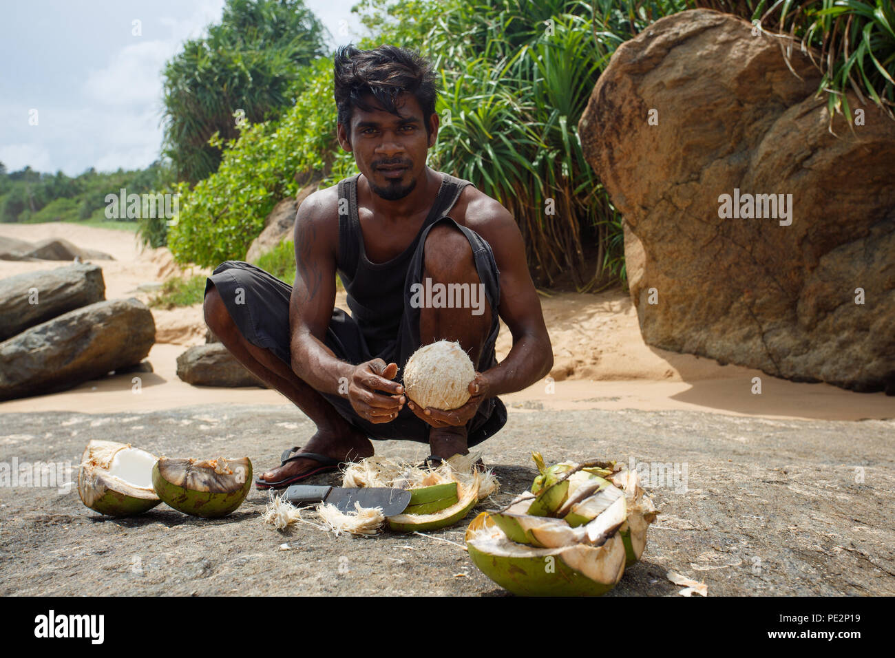 Men posing with a coconut Stock Photo - Alamy