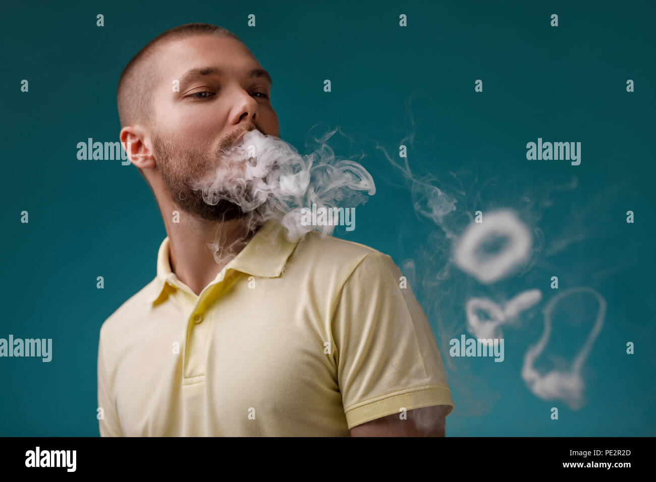 vaping man launches ring of the smoke Stock Photo - Alamy