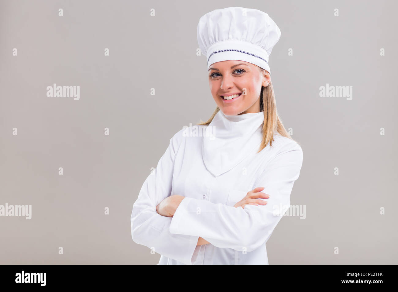Portrait of beautiful female chef on gray background Stock Photo - Alamy