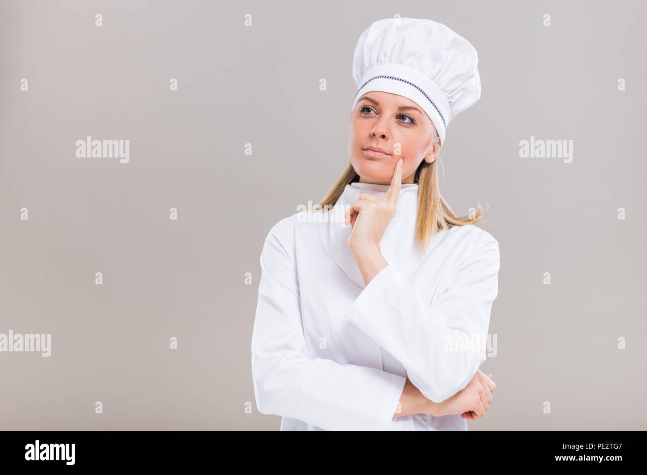 Beautiful female chef is thinking what to cook Stock Photo - Alamy