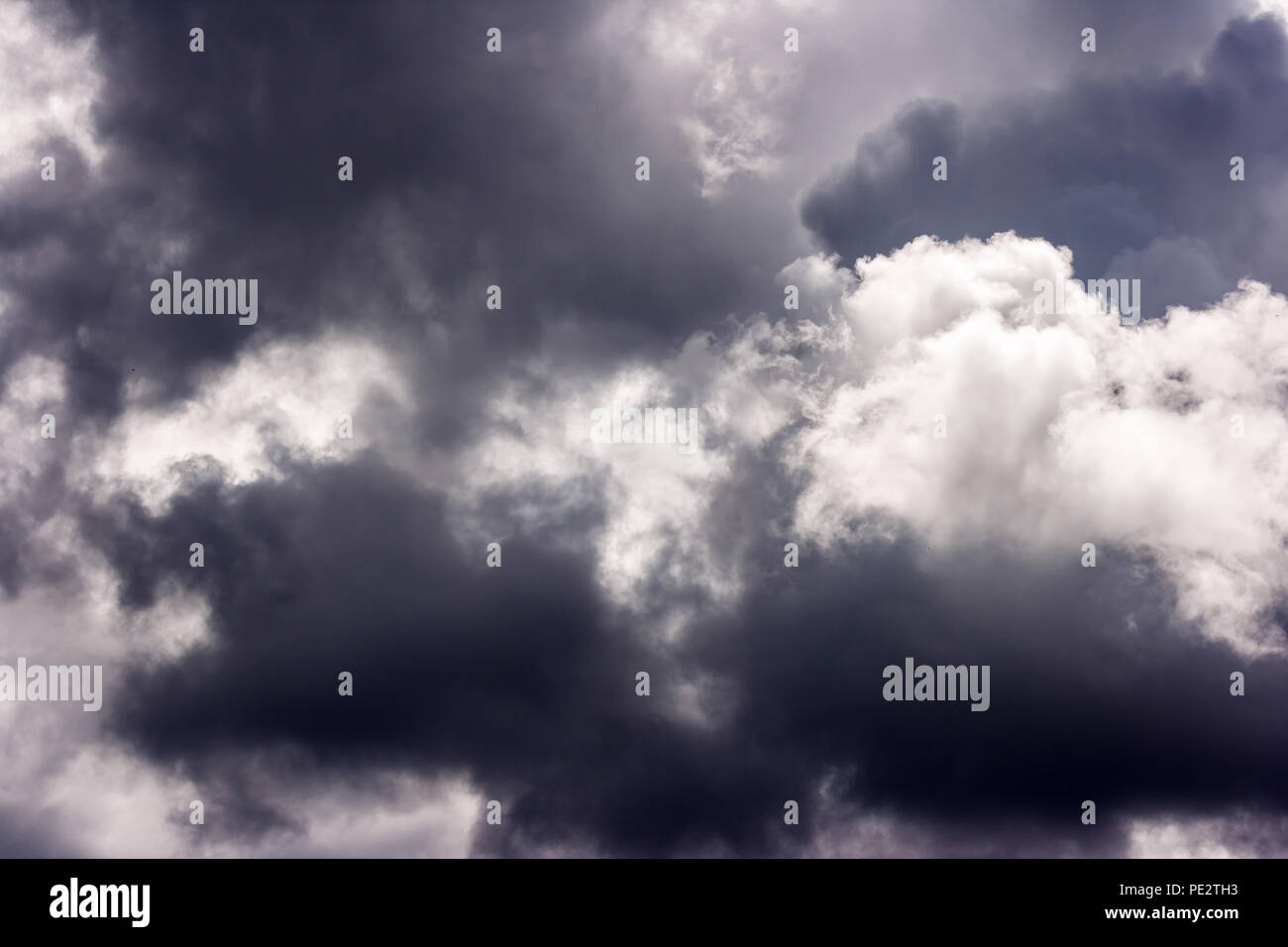 storm cloud on sunny day. light in the dark and dramatic storm slouds ...