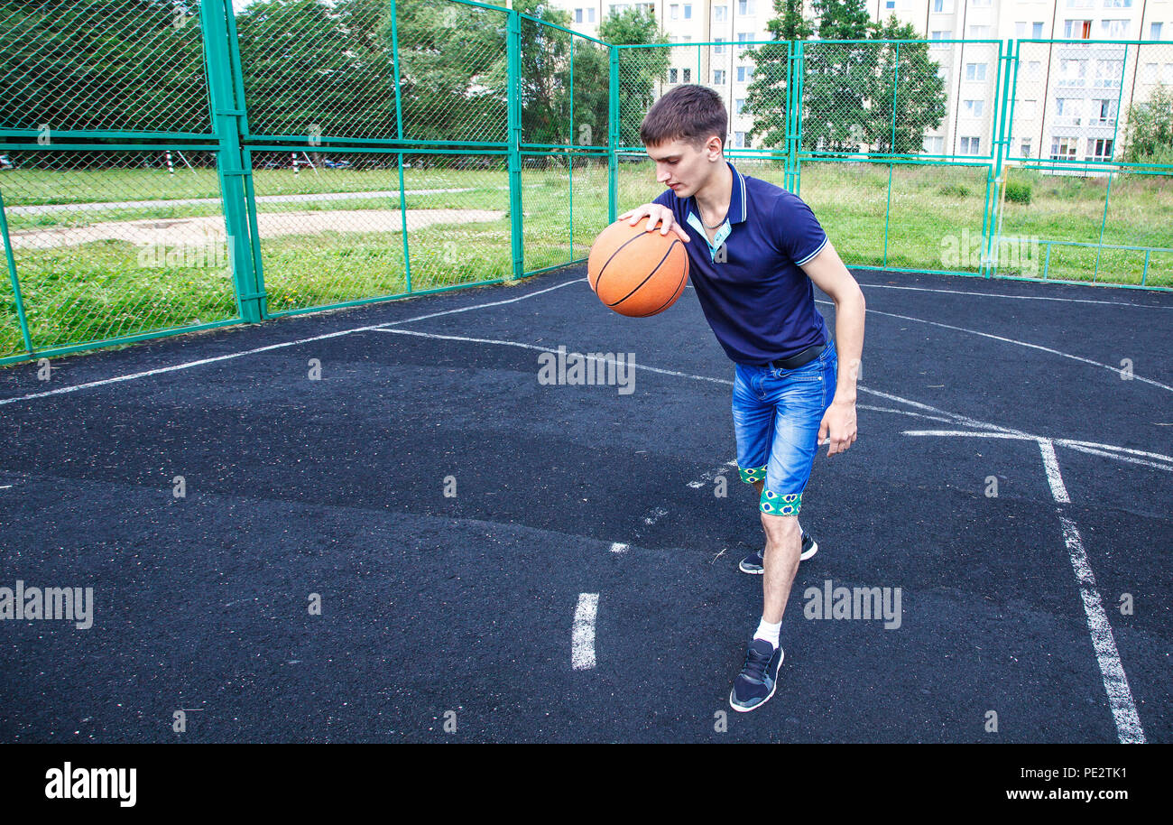 Happy young guy playing basketball hi-res stock photography and images ...