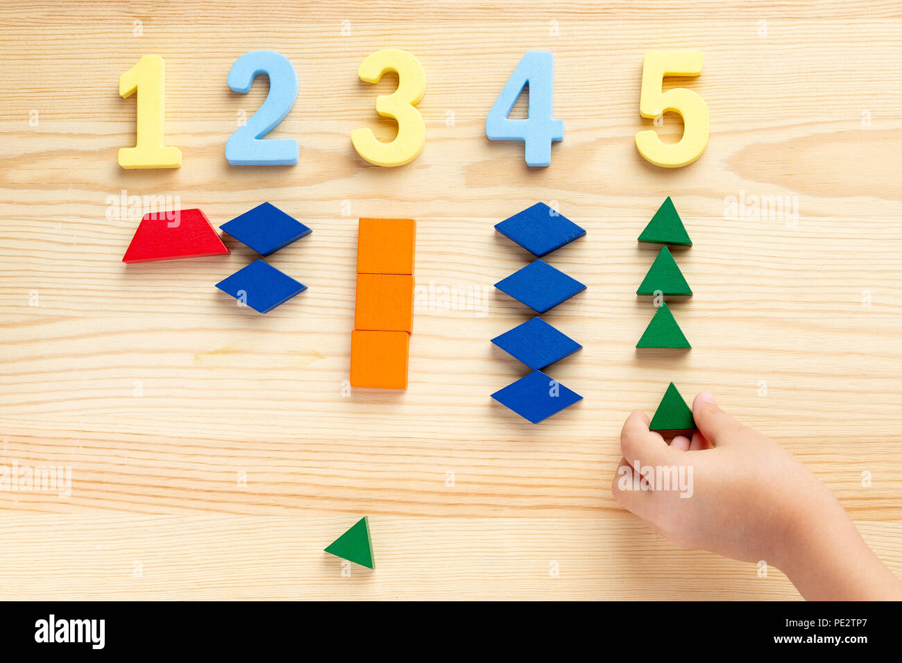The child is studying the numbers and the account. Arranges the colored ...
