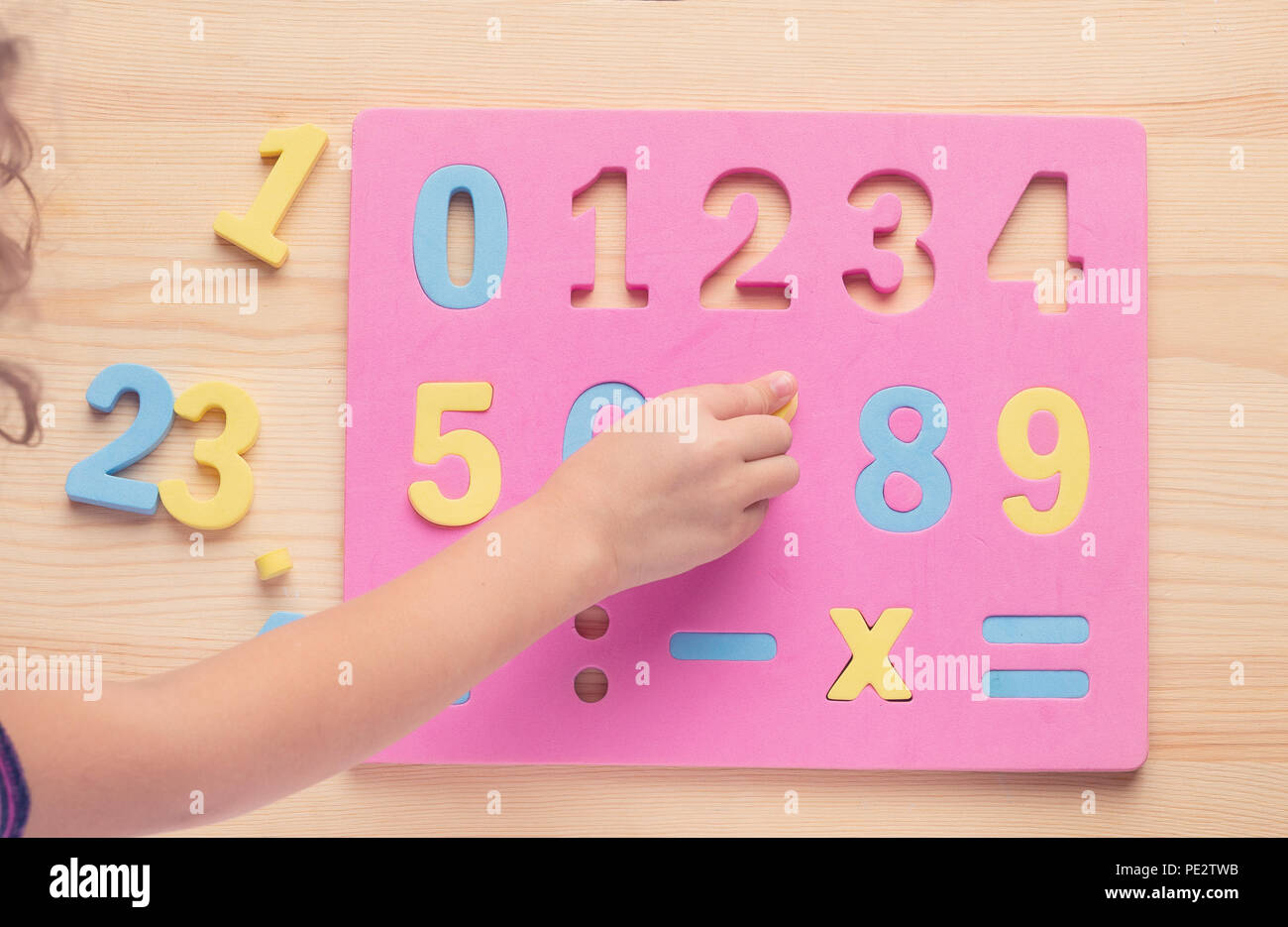 The child is studying the numbers and the account. Arranges the colored ...