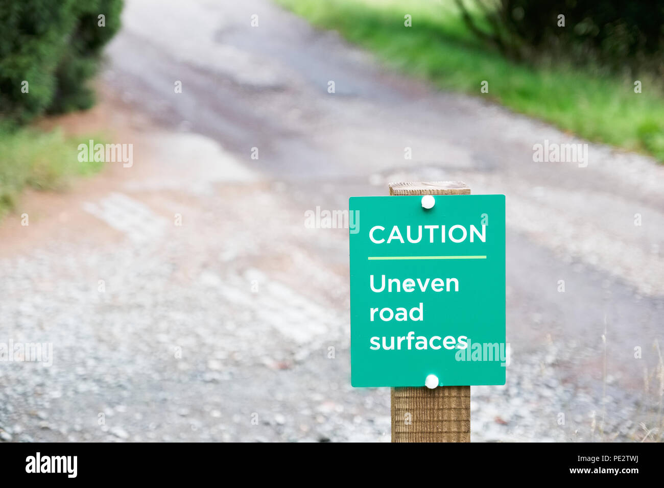 Uneven road surface caution sign for traffic vehicles Stock Photo - Alamy