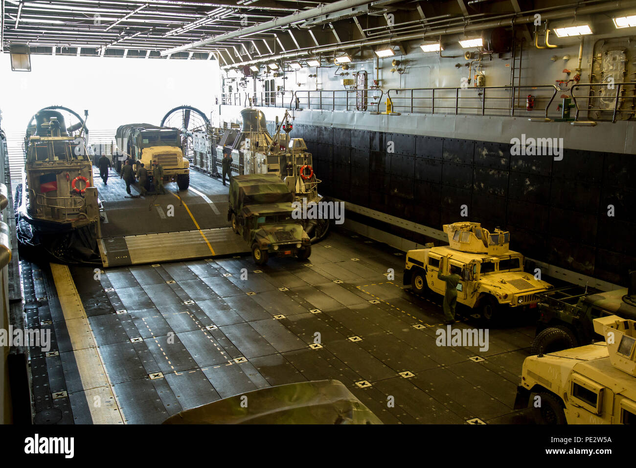 Marines and Sailors load vehicles onto a Landing Craft Air Cushion ...