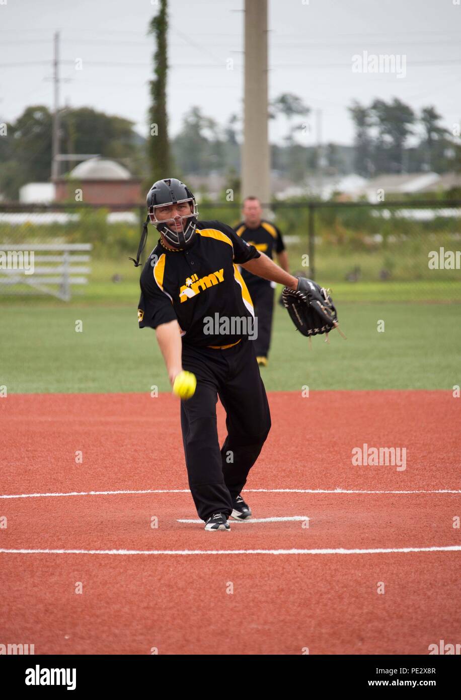 A member of the U.S. Army men’s softball team pitches against the U.S ...