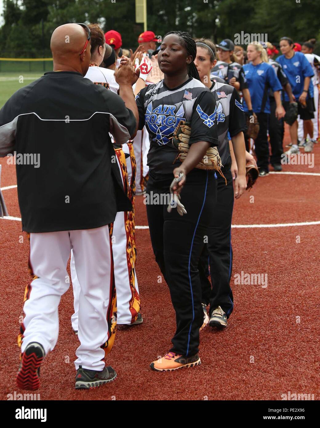 Members of the U.S. Air Force women’s softball team congratulate ...