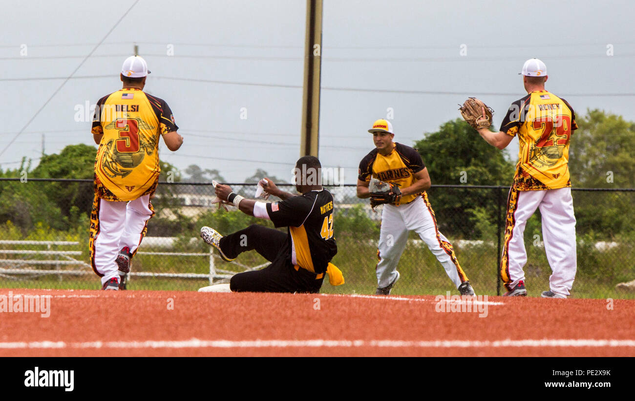 U.S. Army Spc. Jedon Matthews, center, an outfielder for the U.S. Army ...