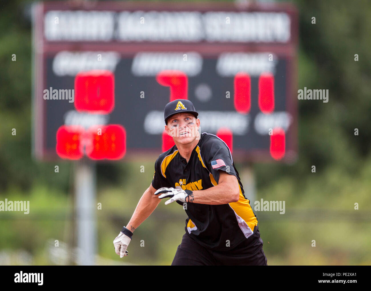 A member of the U.S. Army men's softball team prepares to run to third ...