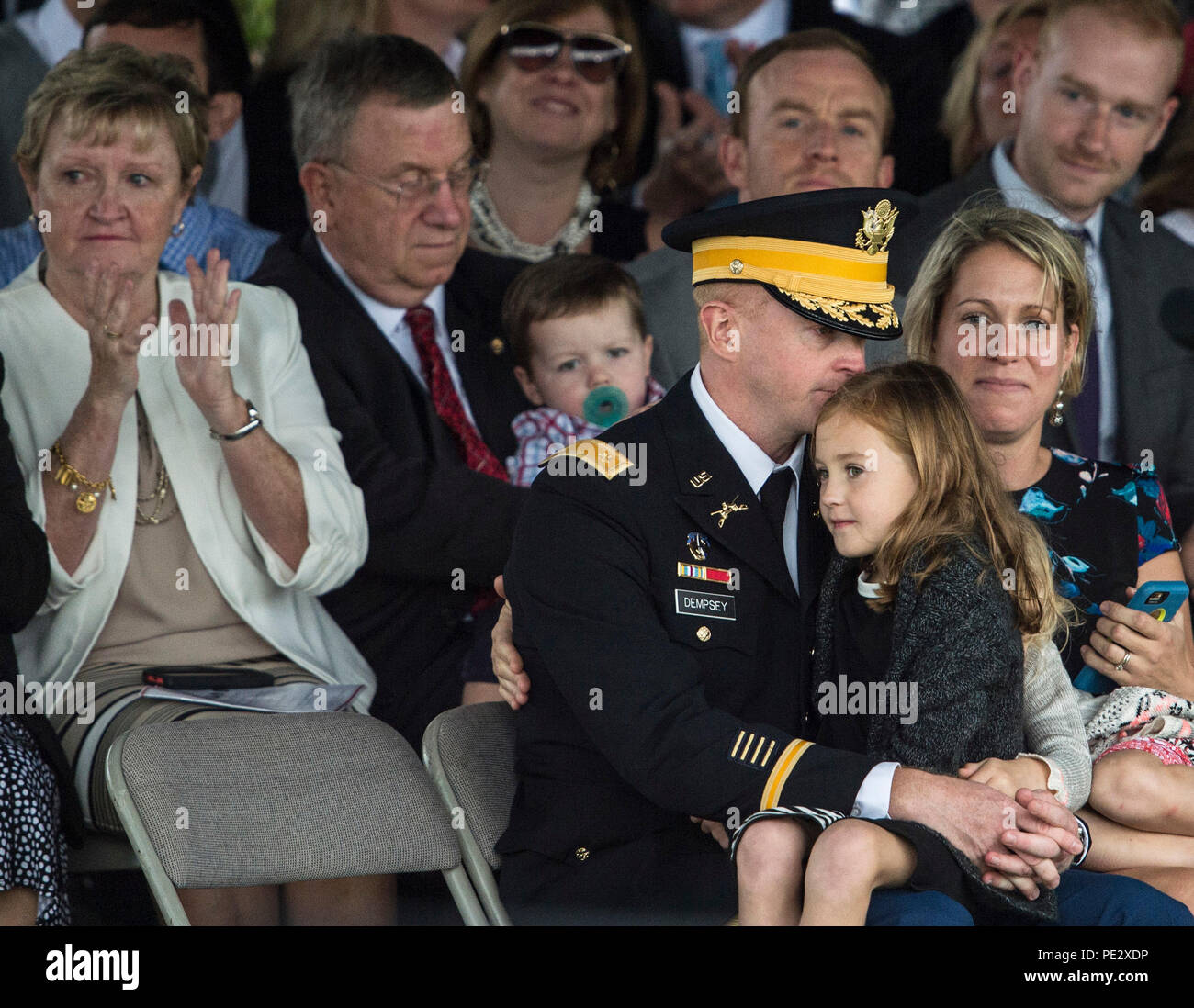 U.S. Army Maj. Christopher Dempsey holds his daughter after reading ...