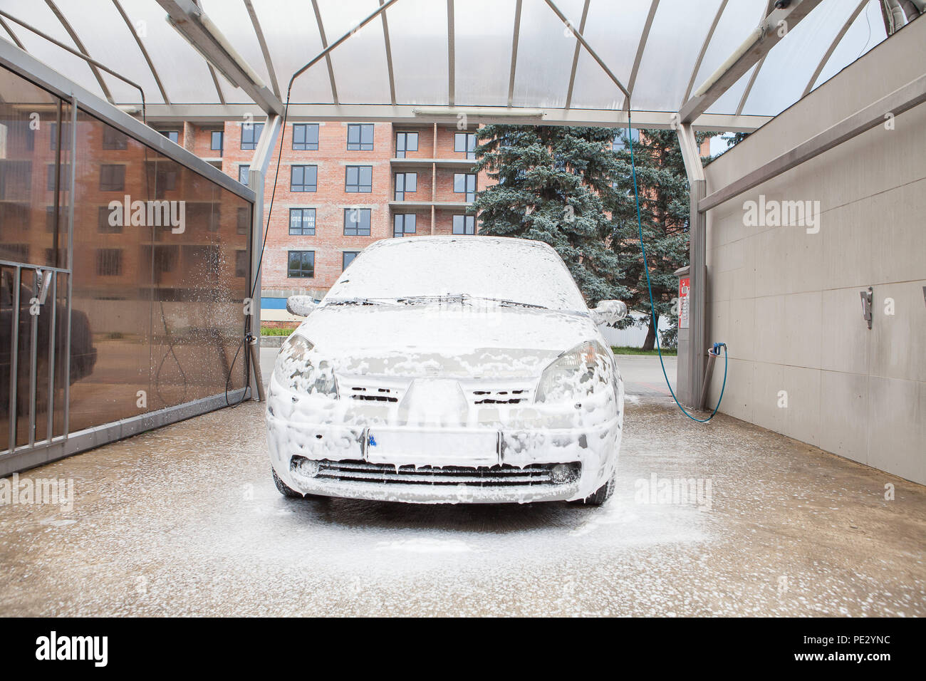 Car wash with foam in car wash station. Carwash. Washing machine at the ...
