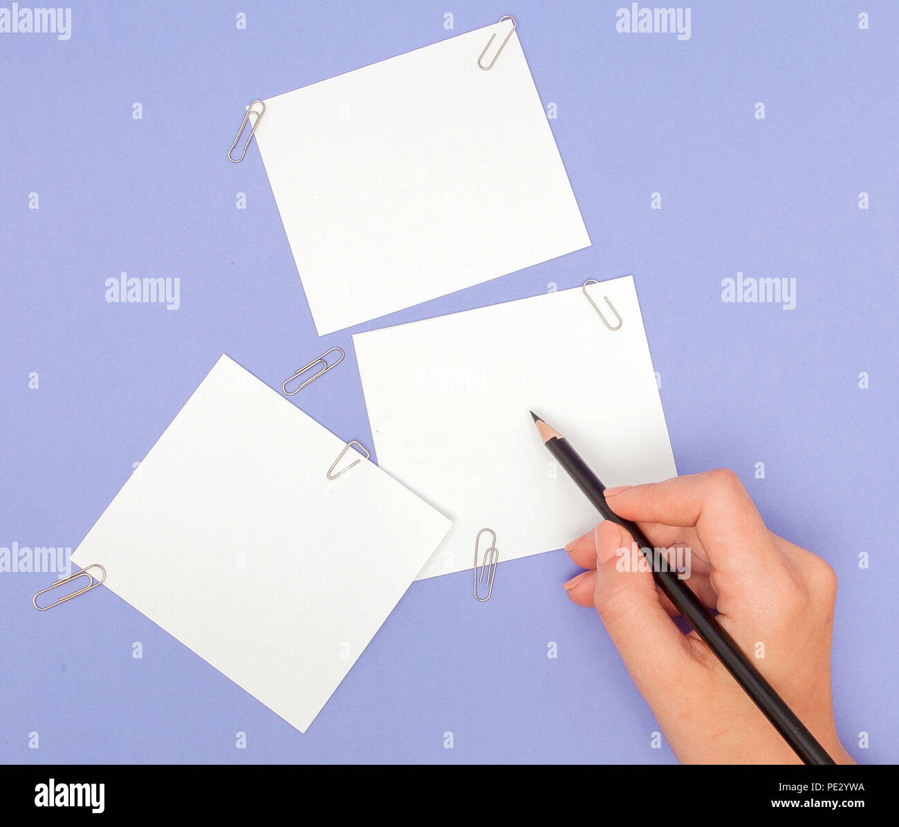 Womens hand writing on note papers on purple background. Blanks sheet ...