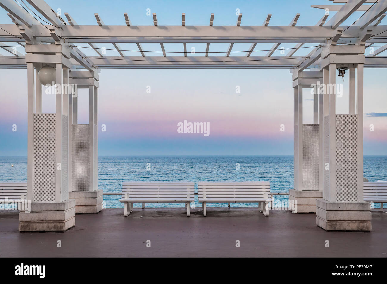 Mediterranean Sea and white colonnade and benches on Promenade des ...