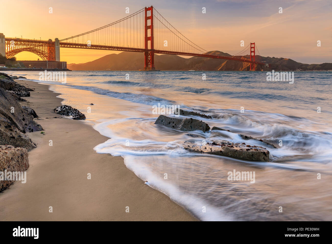 Long exposure of a stunning sunset at the beach by the famous Golden ...