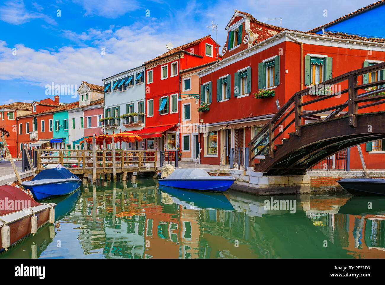 Picturesque canal and bright and colorful houses in Burano island near Venice Italy, which is ...
