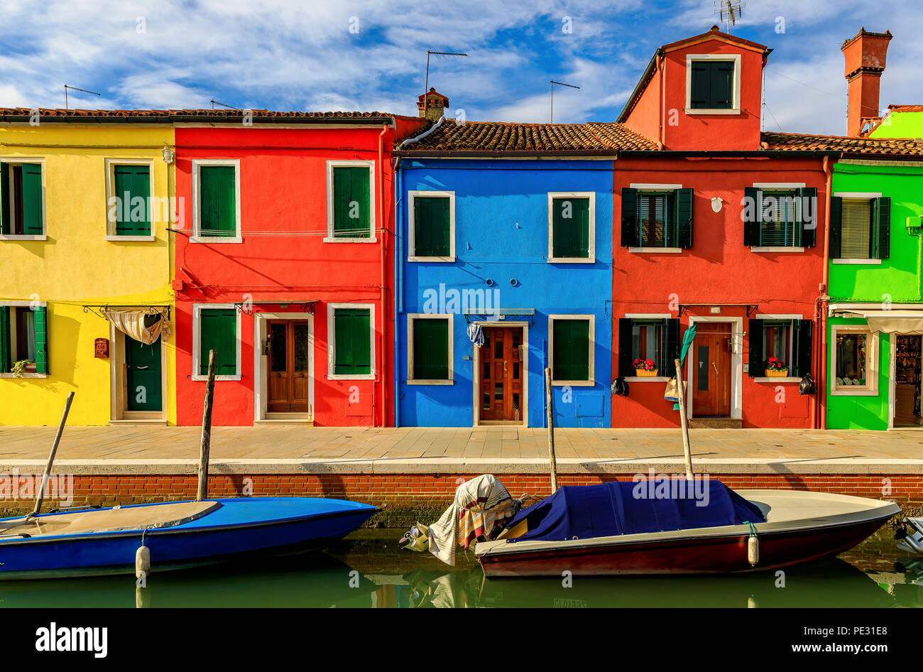Picturesque canal and bright and colorful houses in Burano island near Venice Italy, which is ...