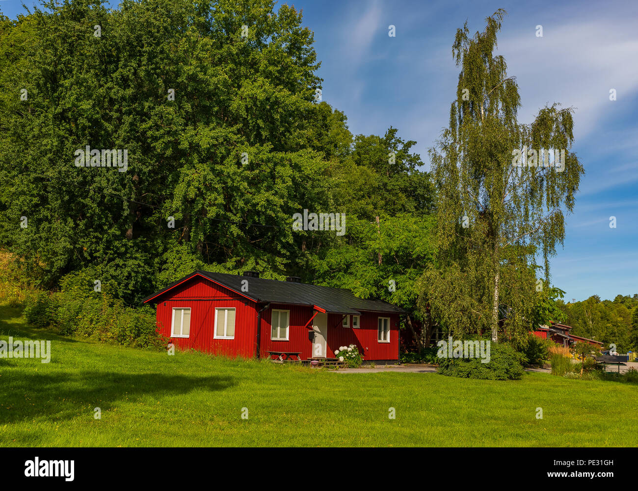 Traditional swedish old house, surrounded by trees in Stockholm, Sweden ...
