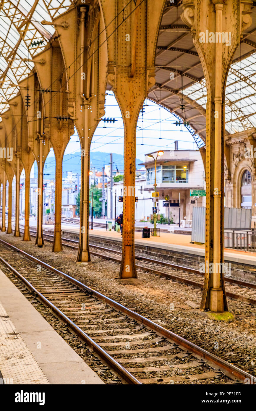 Empty train tracks and rugged columns at the train station in Nice ...