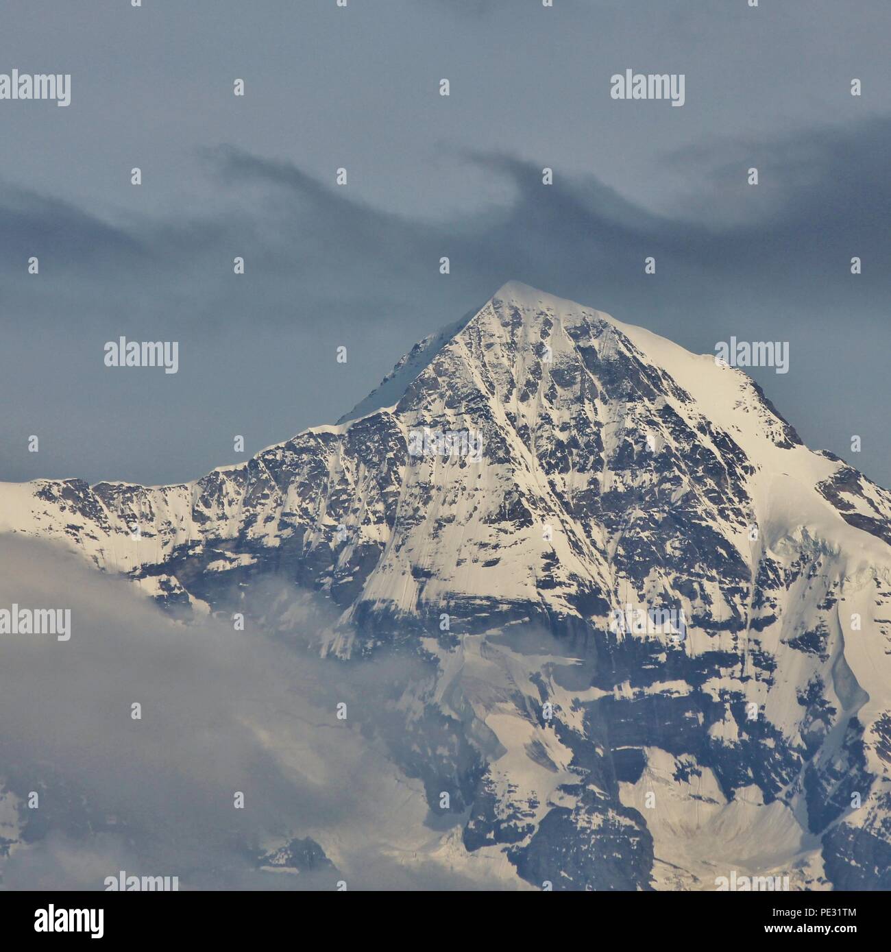 Peak of Mount Monch and clouds. Scene in the Swiss Alps Stock Photo - Alamy