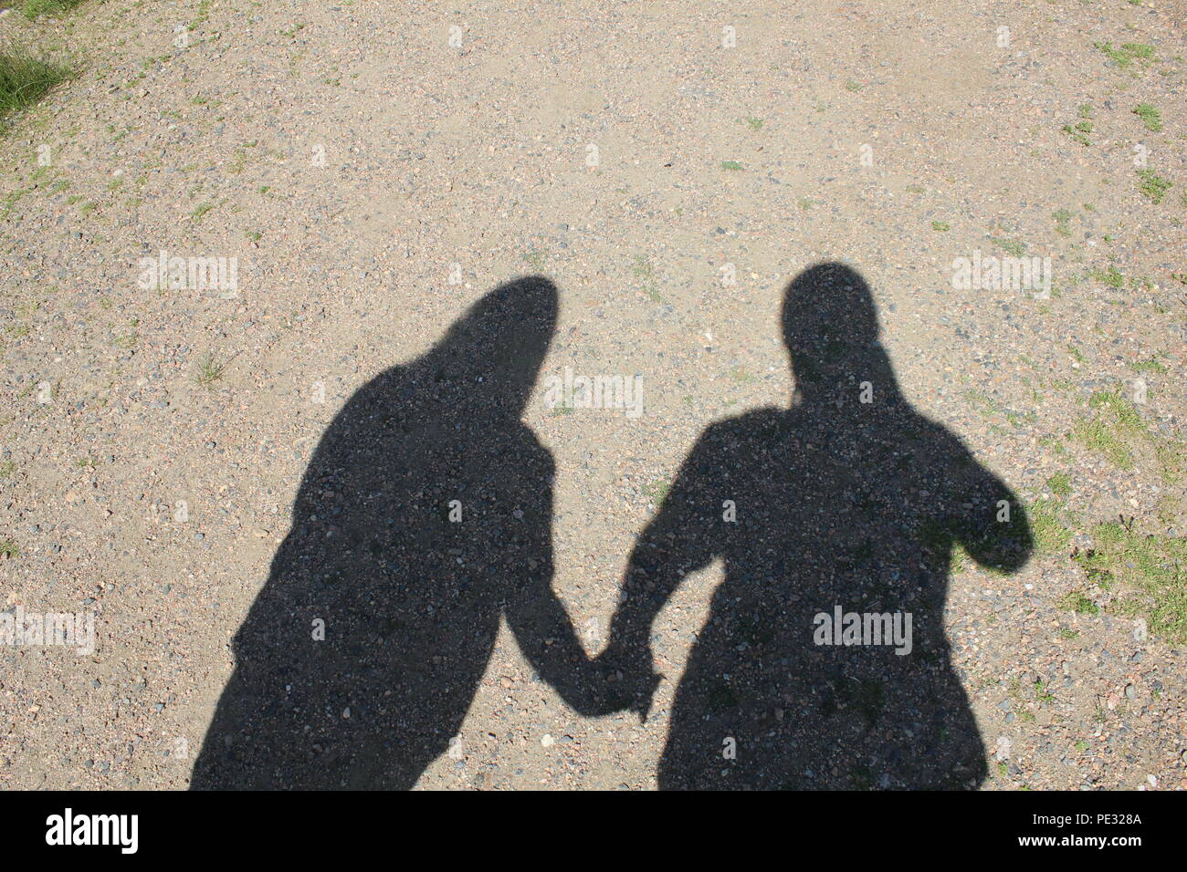 Shadow of a Couple Holding Hands Stock Photo - Alamy