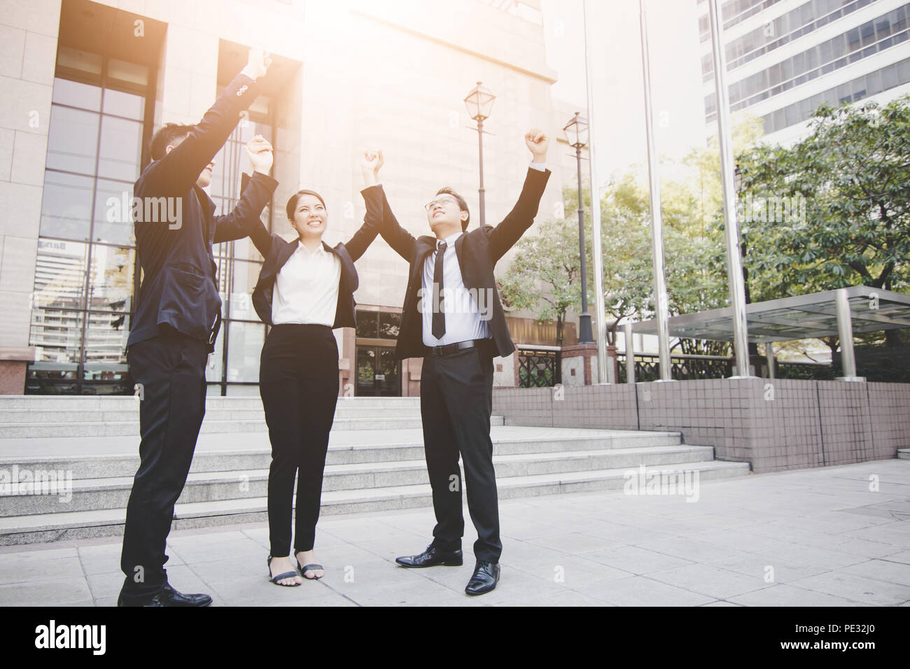 Hand coordination of team businessman on sky infront of bank building ...