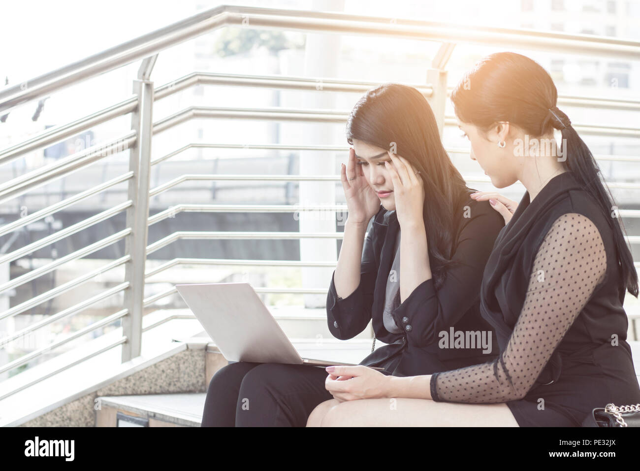 ํYoung businesswomen comforting stress and fear workmate or partner on ...