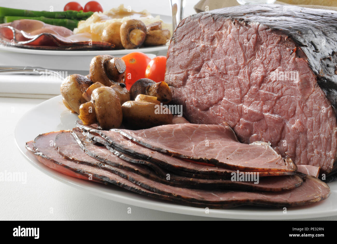 Thin sliced rare roast beef on the dinner table Stock Photo - Alamy