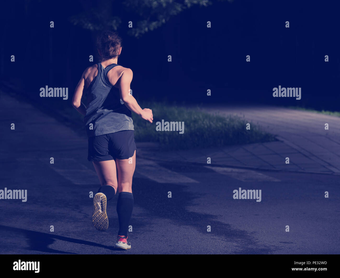 Woman jogging park night hi-res stock photography and images - Alamy