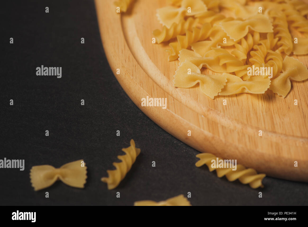 Variety of types and shapes of dry Italian pasta on dark background ...