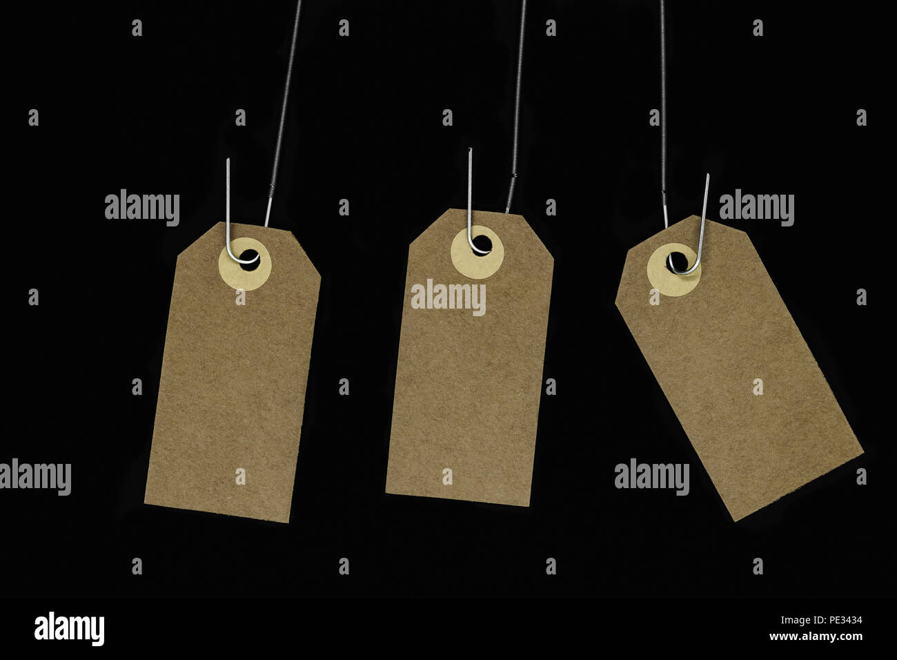 Hanging blank brown note cards with copy space hooked on metal spring ...