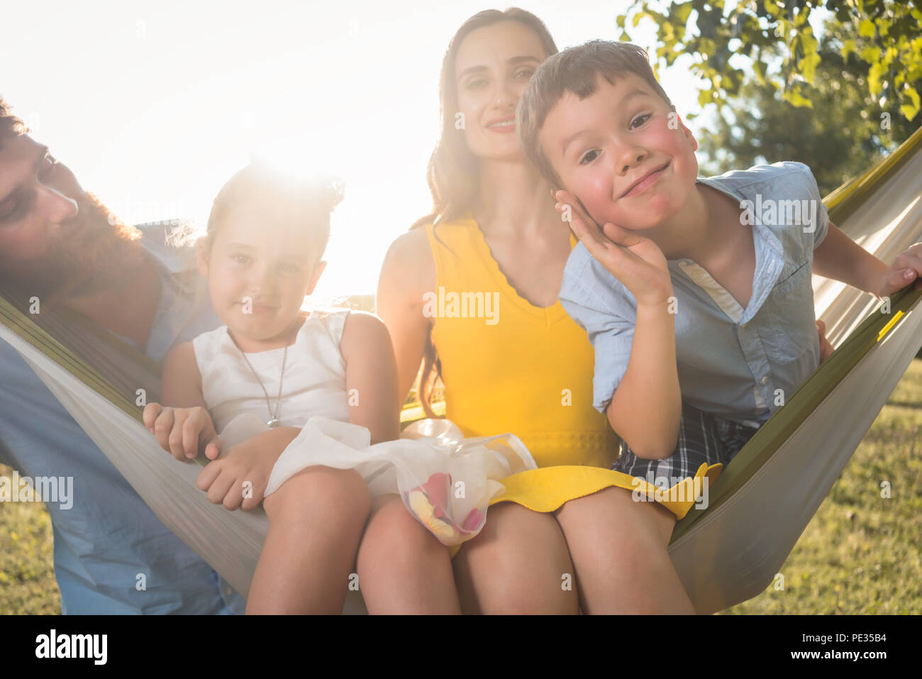 Cute child making funny face while looking at camera for a family ...